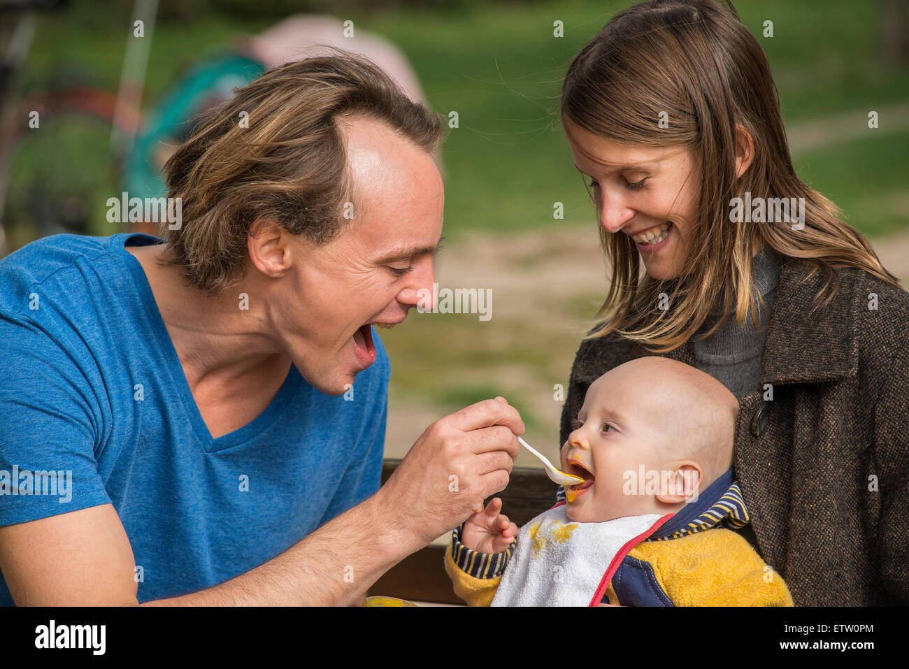 Man feeding his little son Stock Photo - Alamy