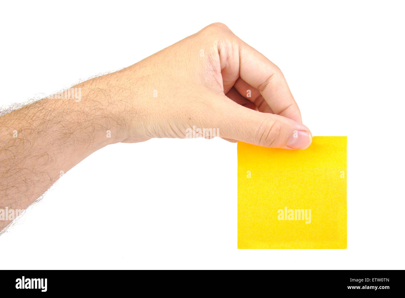 Hand holding a yellow notepaper or post it isolated on white background ...