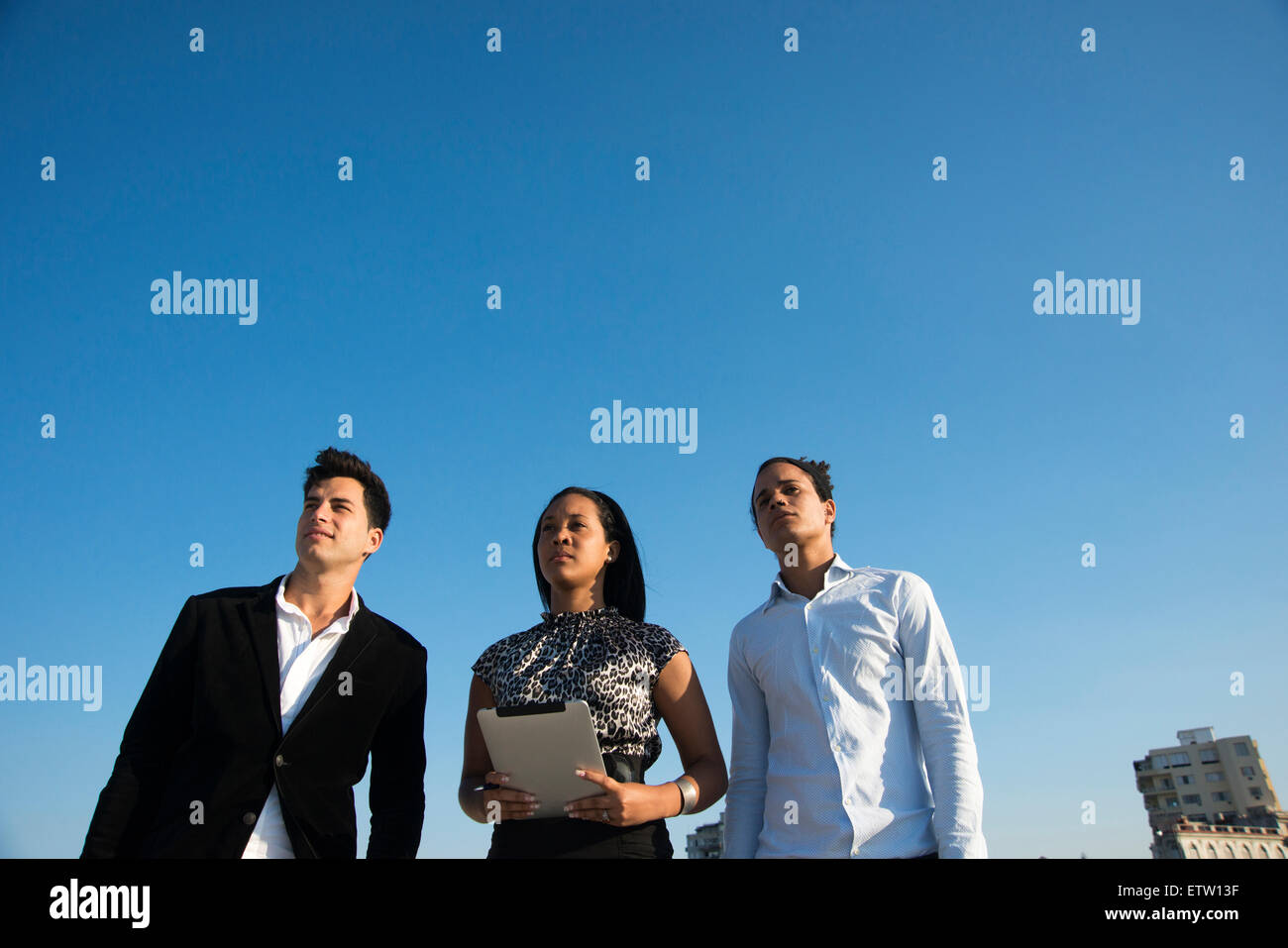 Three Latin executives outdoors Stock Photo - Alamy