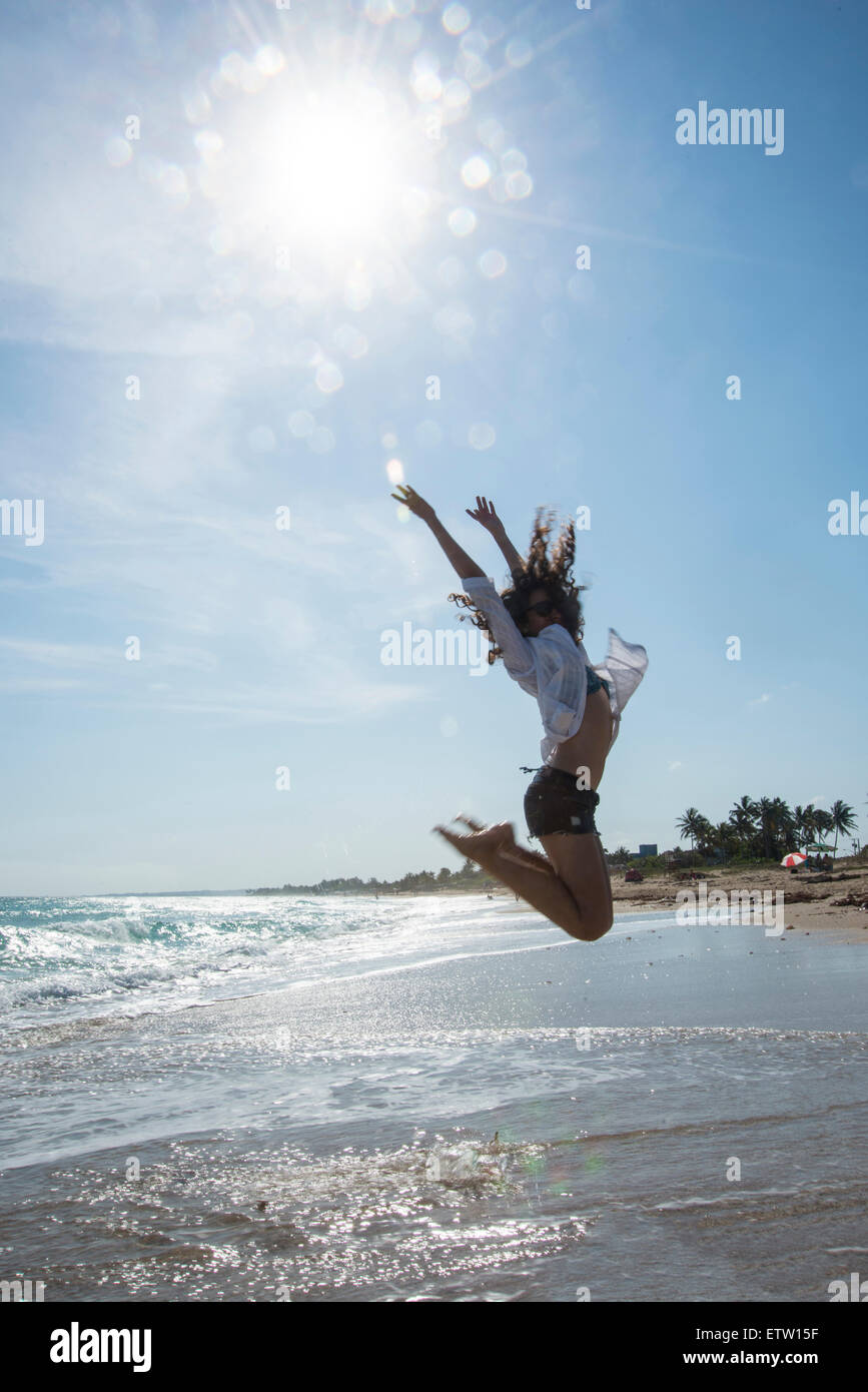 Woman jumping on beach Stock Photo - Alamy