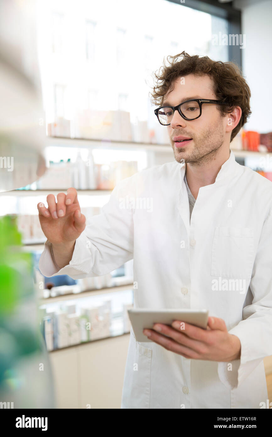 Portrait of pharmacist doing inventory control with digital tablet ...