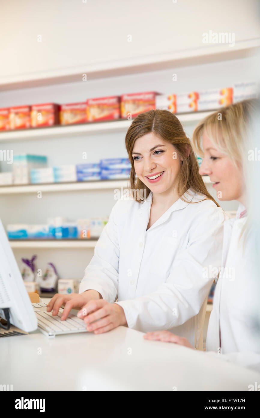 Two female pharmacists looking at computer screen Stock Photo - Alamy