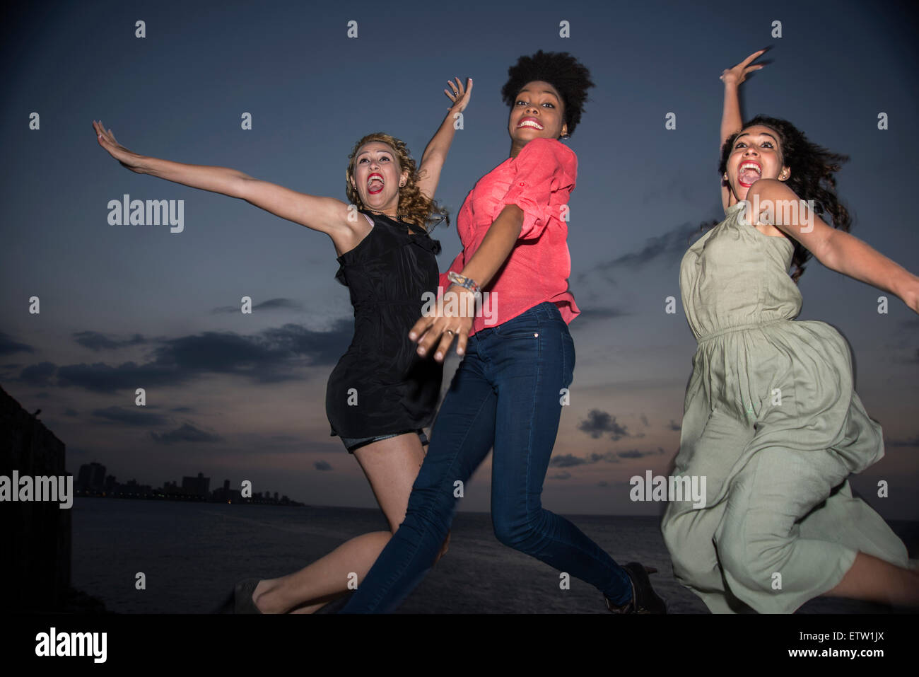 Three Latin women jumping Stock Photo - Alamy