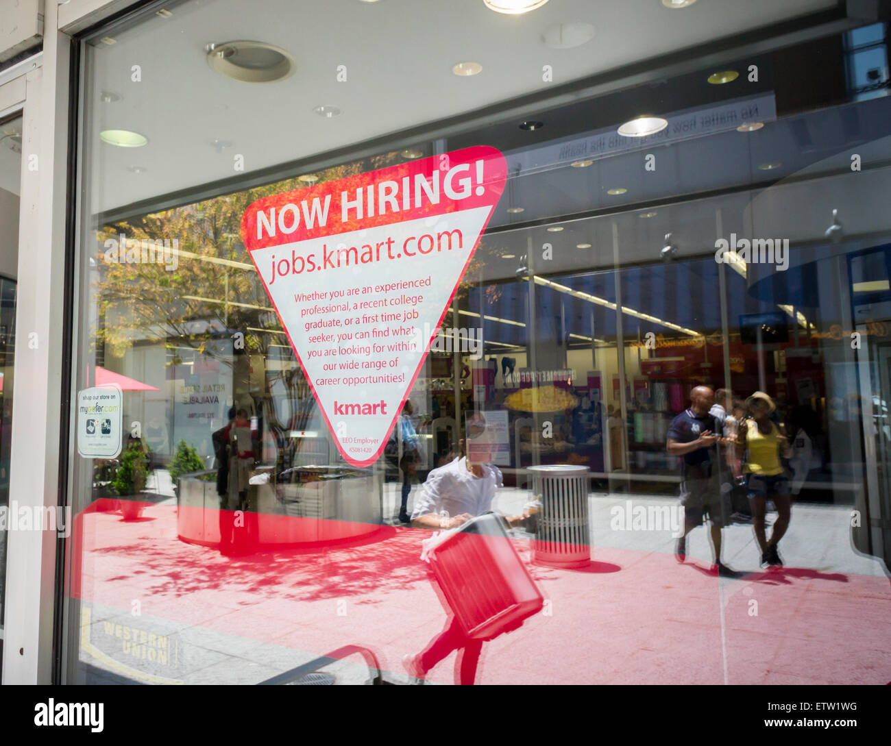 A sign on the window of a KMart store in New York advertises that it is ...