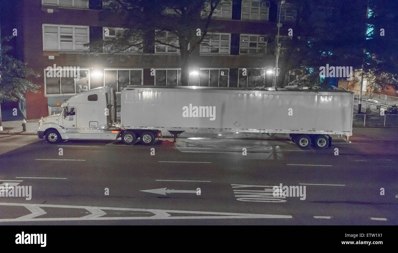 A large tractor trailer truck is parked in the Chelsea neighborhood in ...