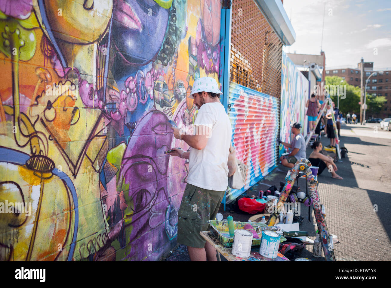 Street artist Cern and other artists at work at the Welling Court Mural ...