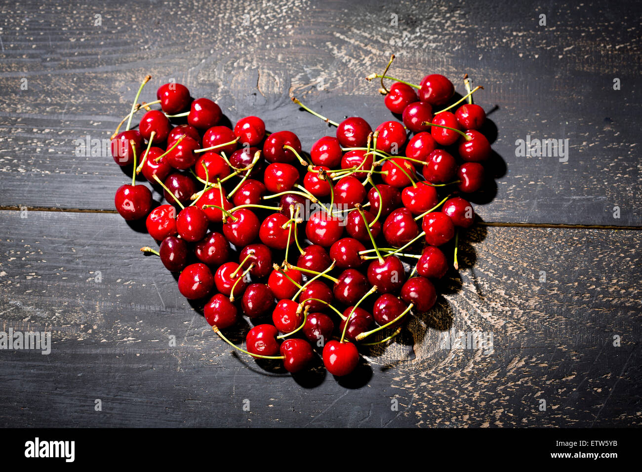 Cherries shaped like a heart on wood Stock Photo - Alamy