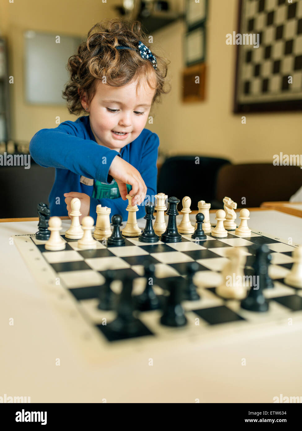 Little girl playing chess Stock Photo - Alamy