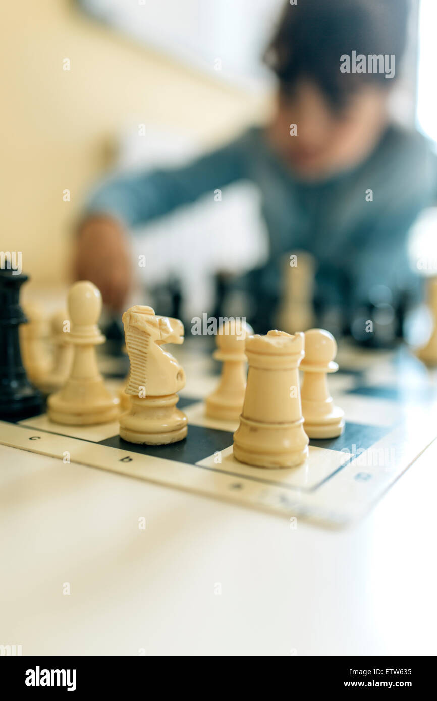 Boy playing chess Stock Photo - Alamy