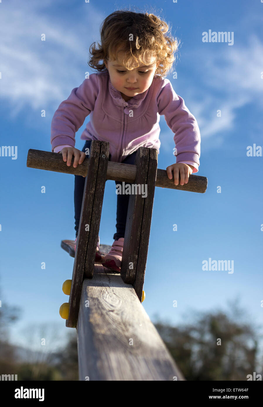Little girl standing on a rocker hi-res stock photography and images ...