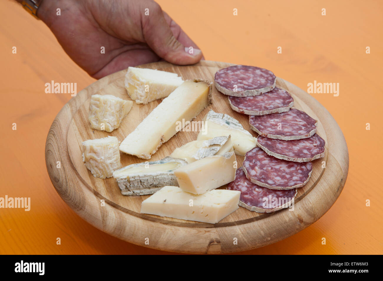 Mixed cheeses wooden platter and salami, italian food Stock Photo - Alamy