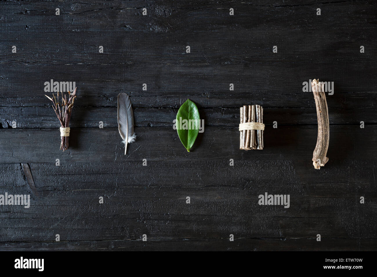Row of organic natural material on black wood Stock Photo - Alamy