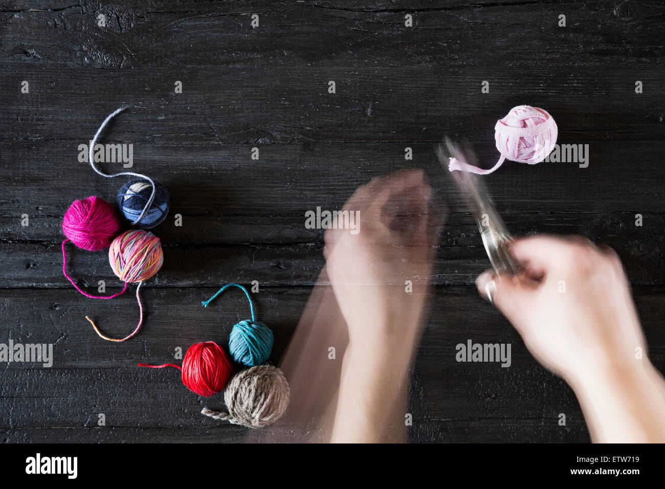 Moving hands cutting thread of wool Stock Photo - Alamy