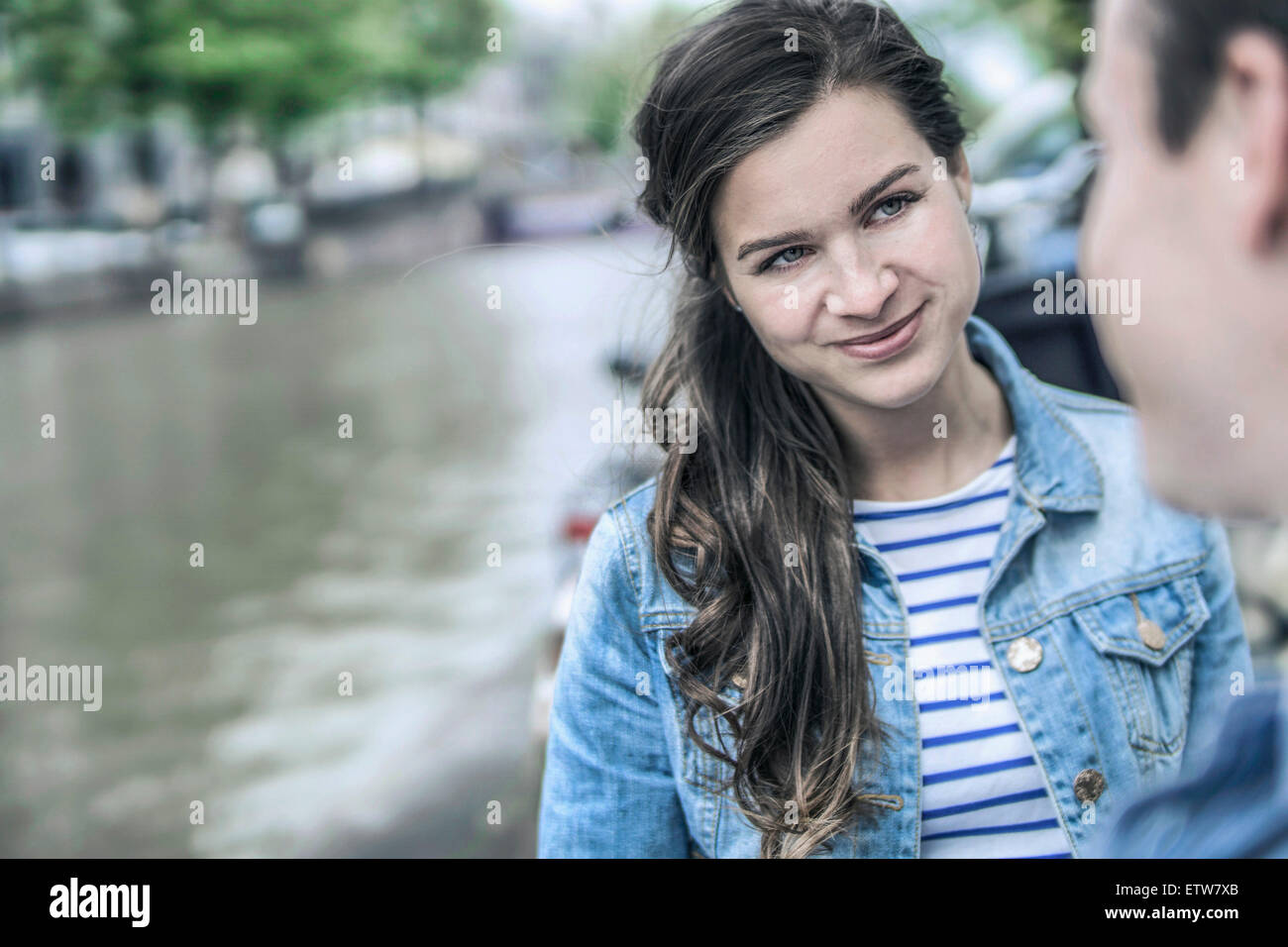 Netherlands, Amsterdam, portrait of smiling woman face to face with a ...