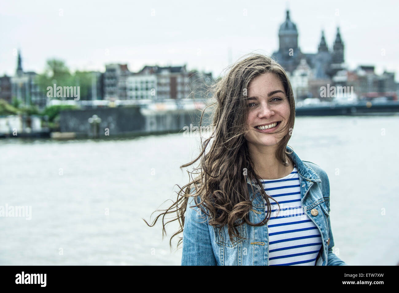 Netherlands, Amsterdam, portrait of smiling female tourist Stock Photo ...