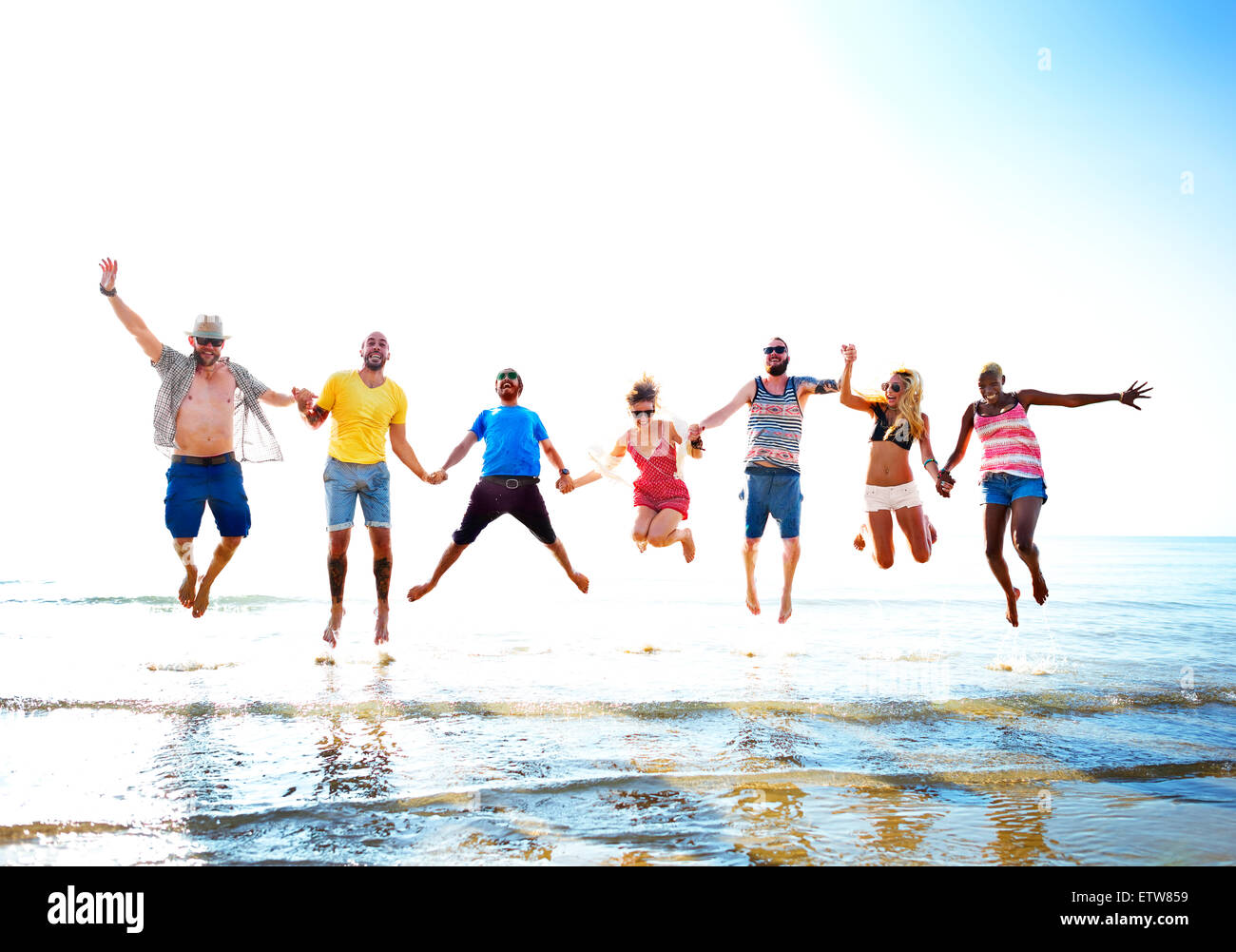 Diverse Beach Summer Friends Fun Jump Shot Concept Stock Photo - Alamy