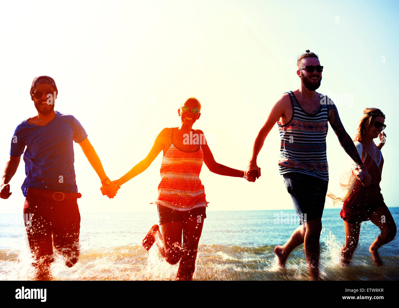 Beach sunset friends holding hands hi-res stock photography and images ...