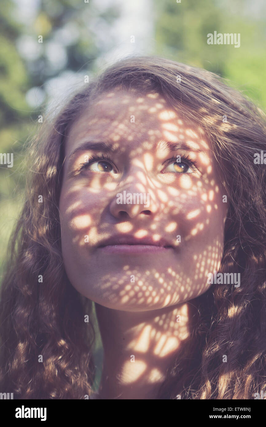 Young woman in shadow looking up Stock Photo - Alamy