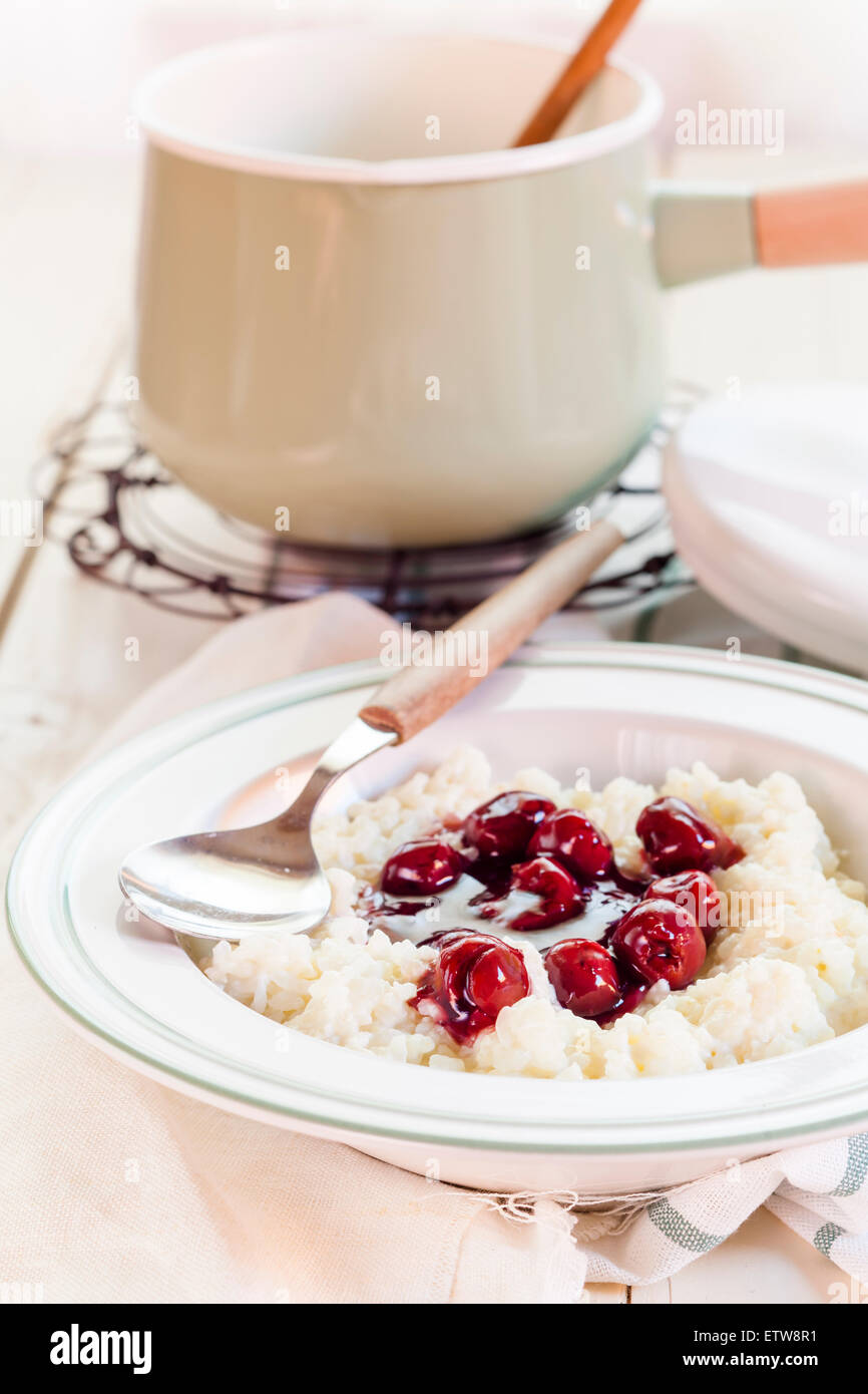 Rice pudding with cherry sauce Stock Photo - Alamy