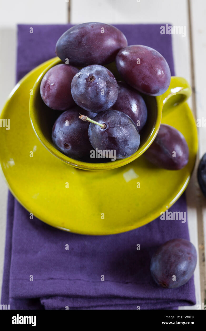 Plums in a cup Stock Photo - Alamy