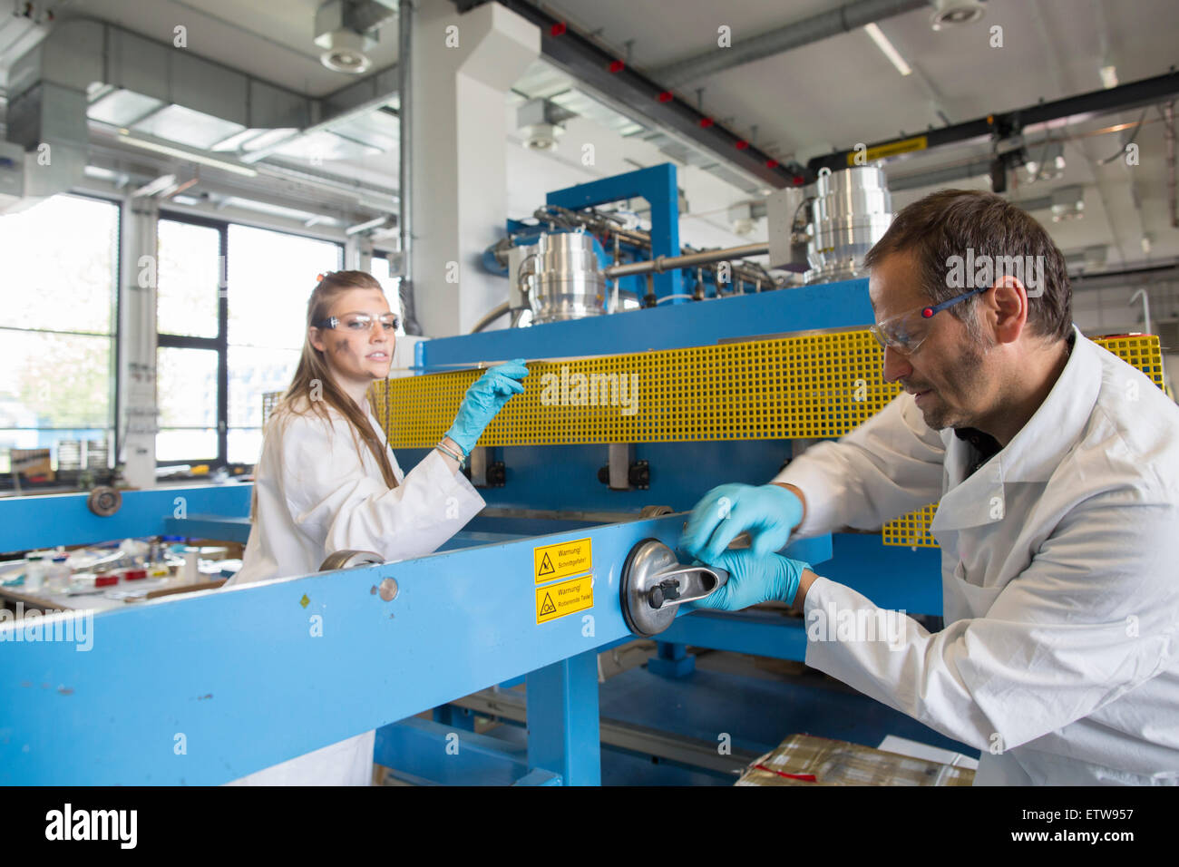 Two technicians controlling machines Stock Photo - Alamy