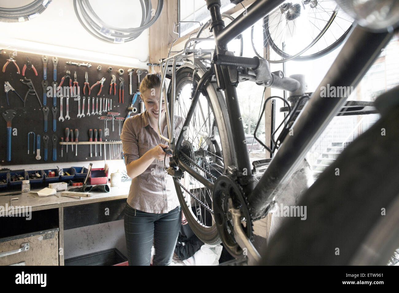 Smiling young woman repair hi-res stock photography and images - Alamy