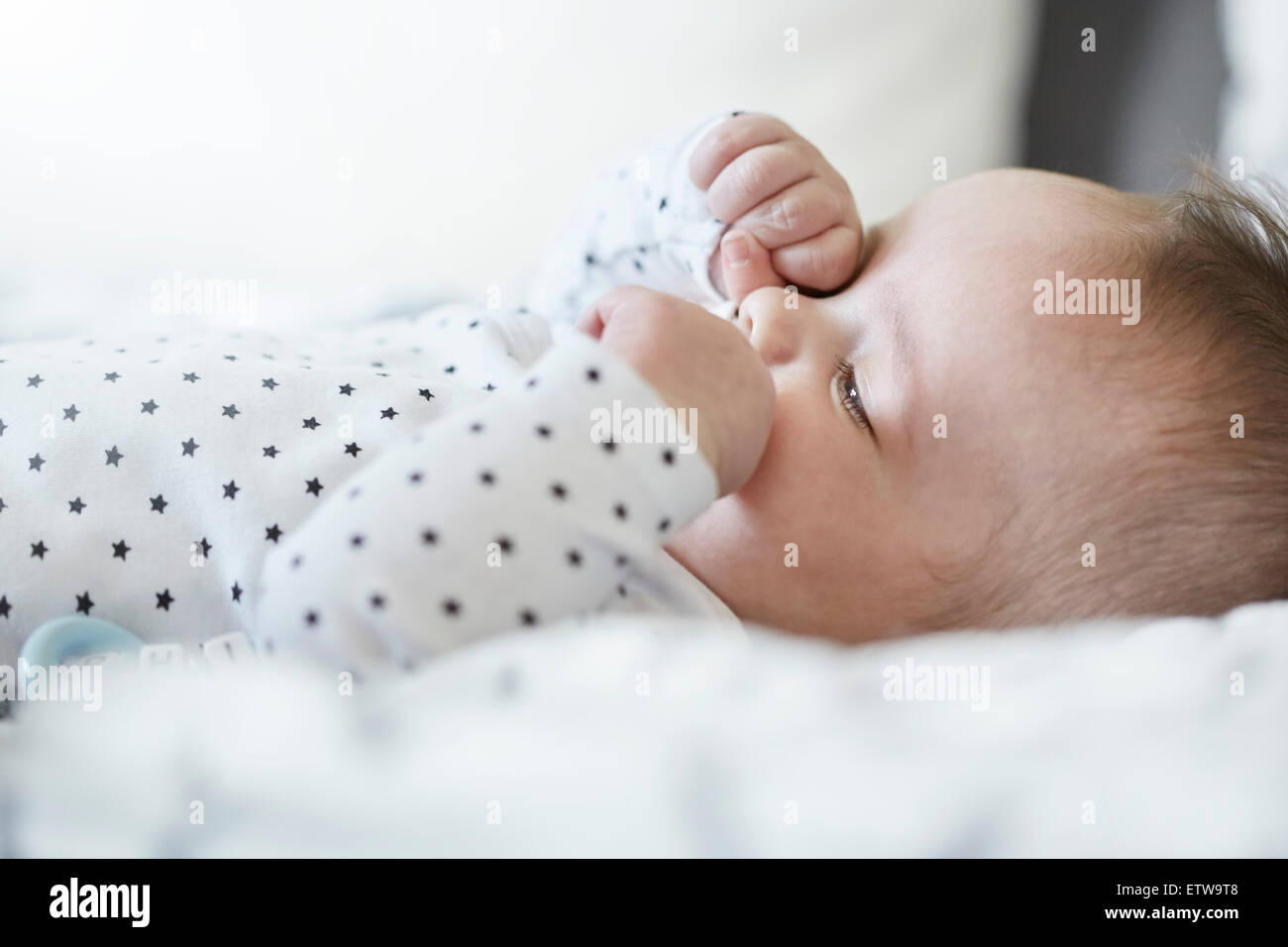 Tired baby lying down Stock Photo - Alamy