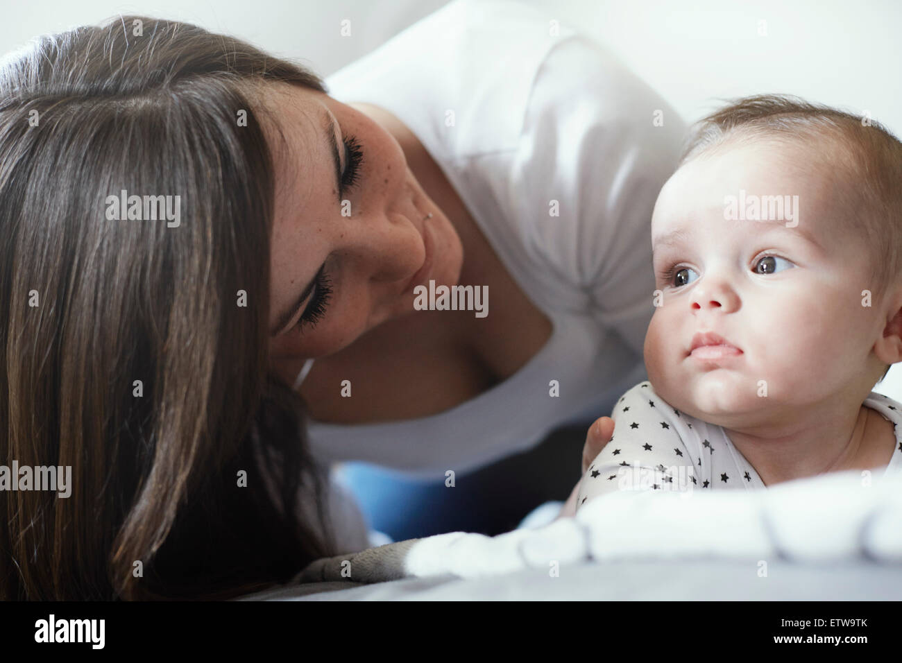 Young mother looking at baby Stock Photo - Alamy