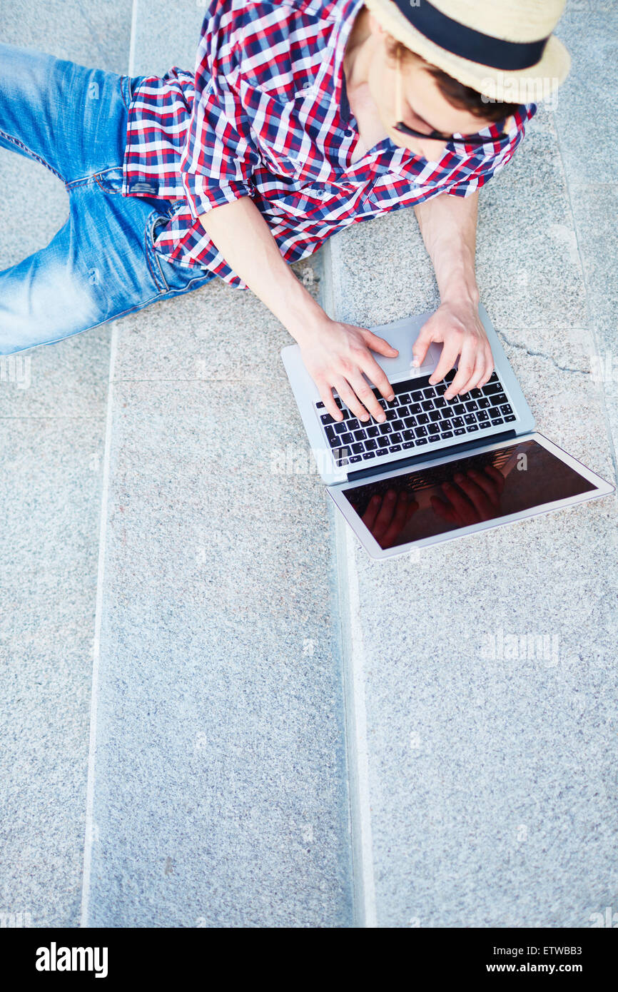 Modern guy networking on stairs outdoors Stock Photo - Alamy