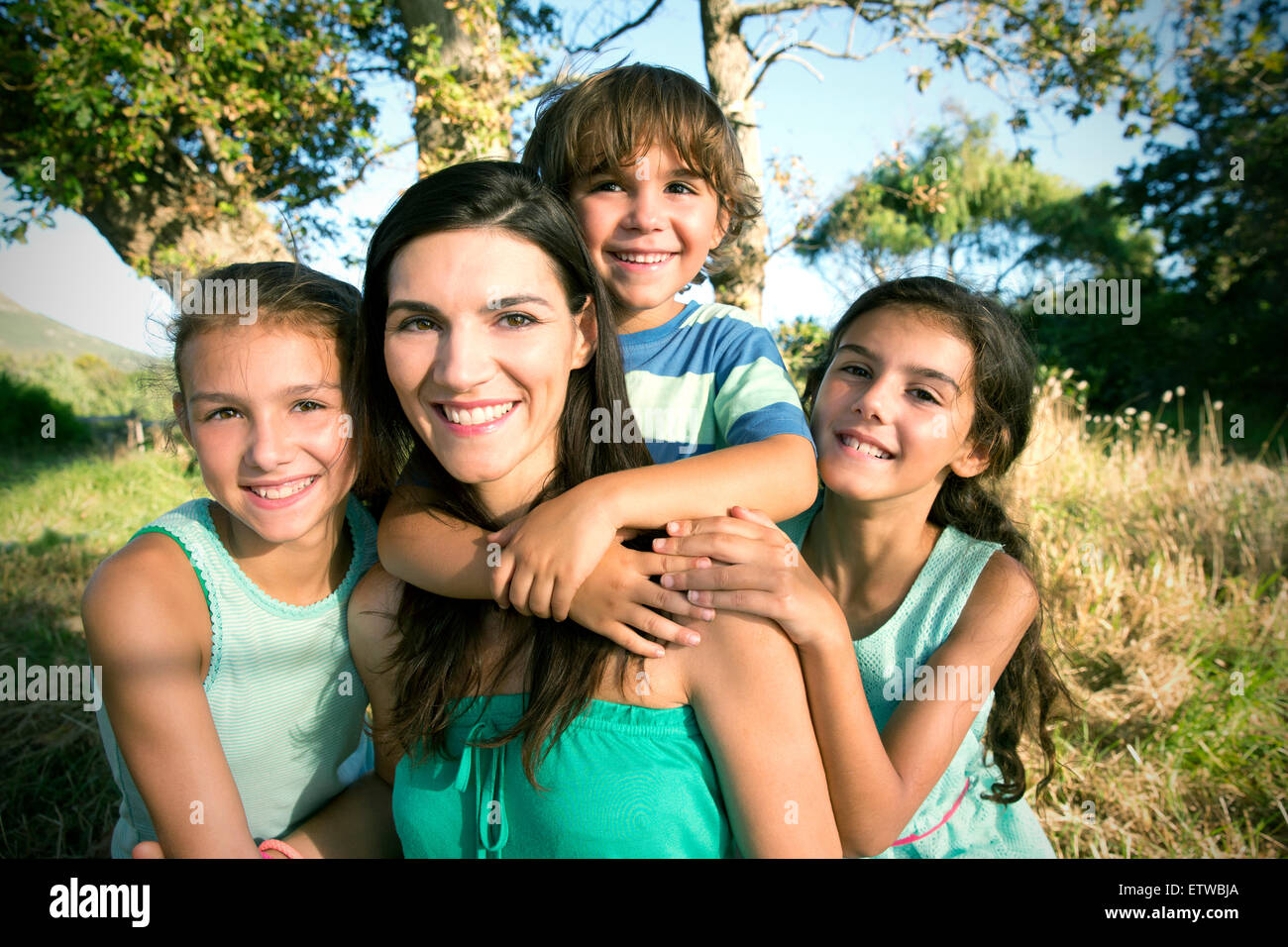 Happy mother with her family outdoors Stock Photo - Alamy