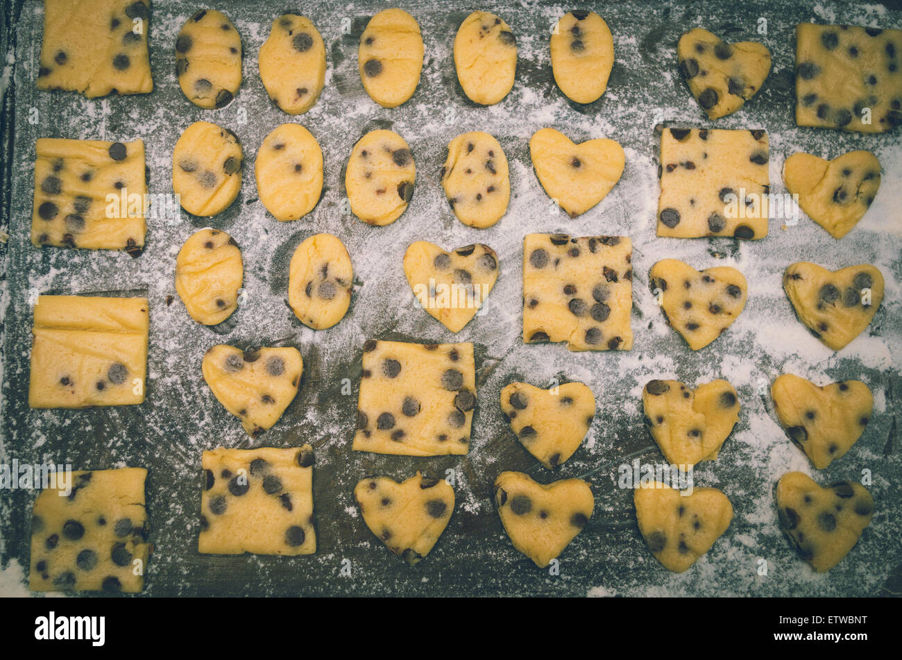Large assortment of chocolate chip cookies in various shapes before ...