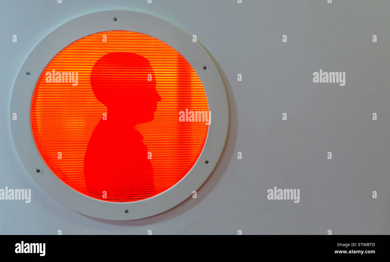 orange hatch on a gray wall with image human Stock Photo - Alamy