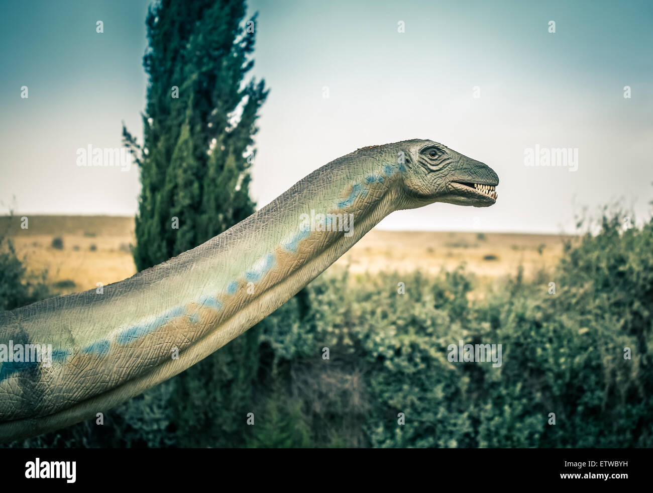ancient extinct dinosaur on a background of plants Stock Photo - Alamy