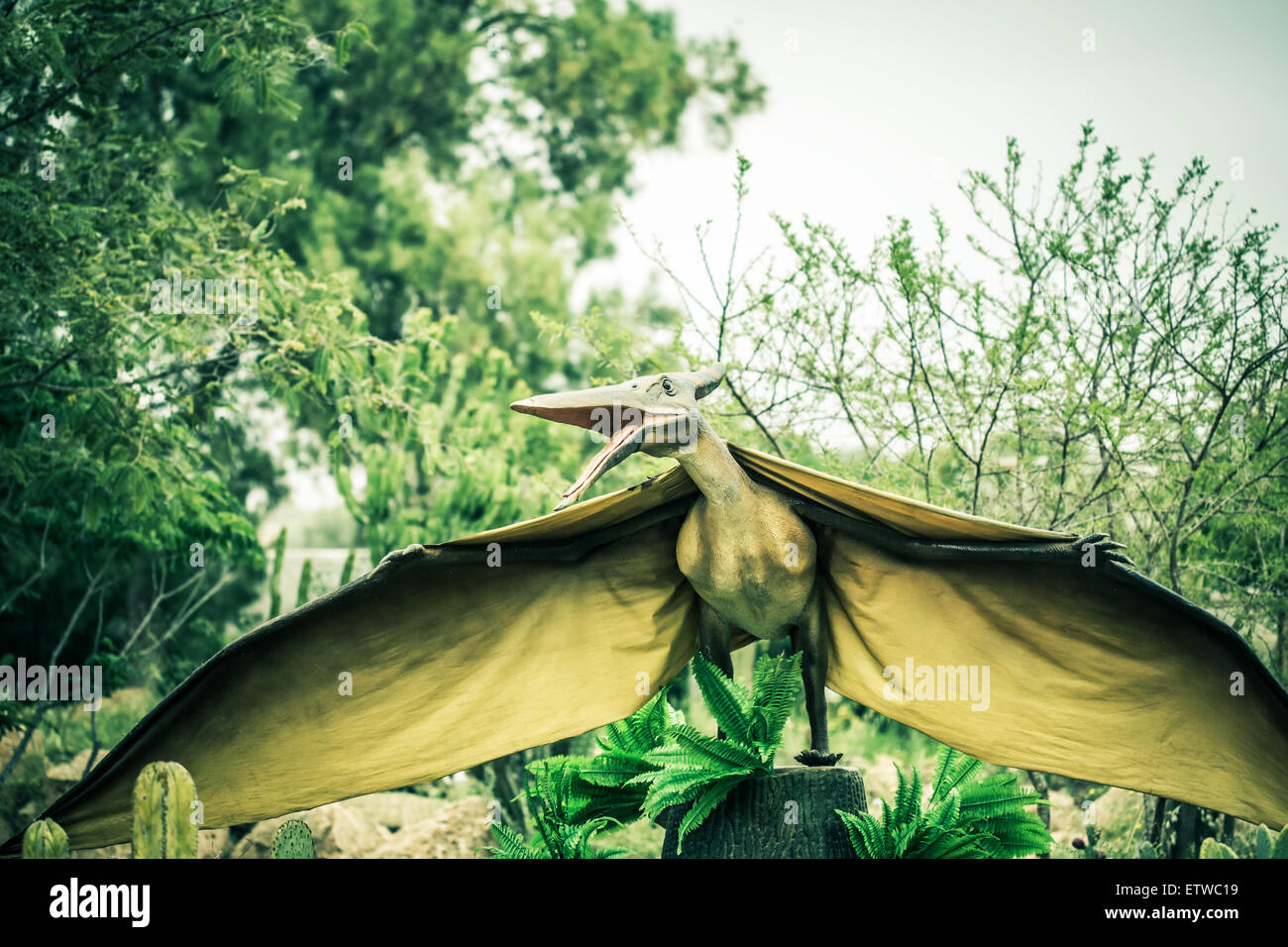 ancient extinct dinosaur on a background of plants Stock Photo - Alamy