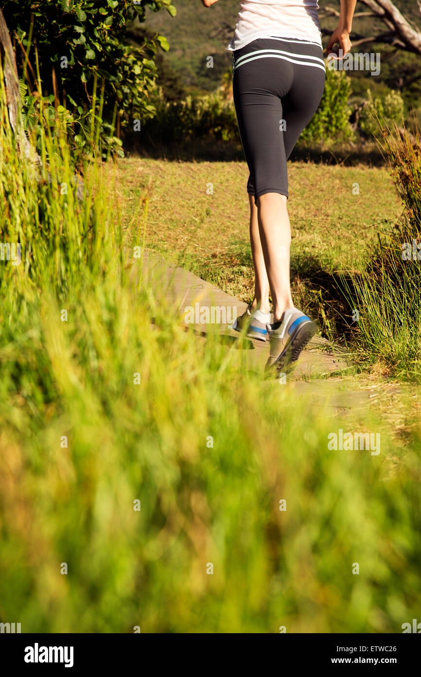 Woman jogging in rural landscape Stock Photo - Alamy