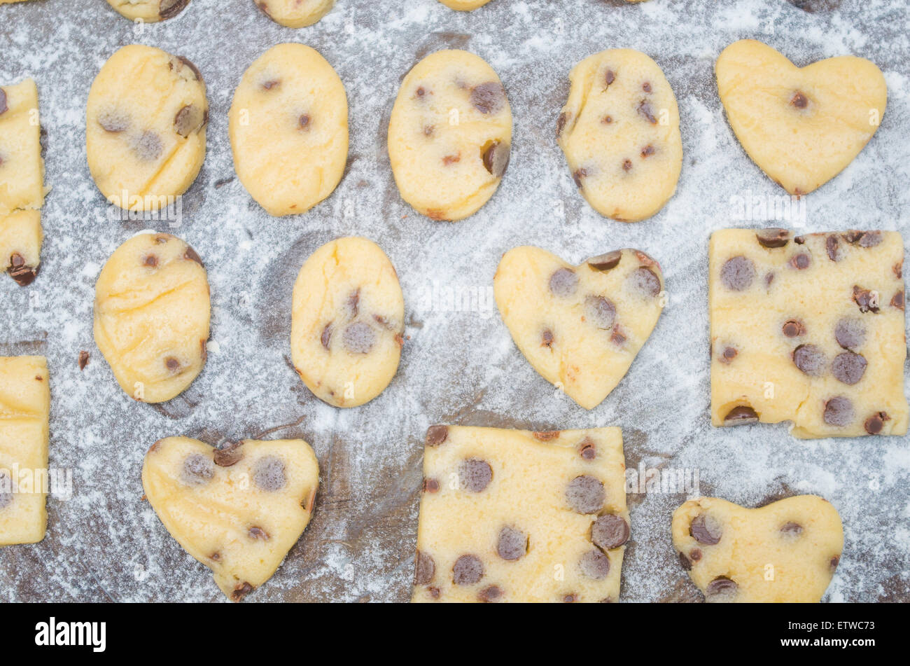 Closeup of large assortment of chocolate chip cookies in various shapes ...