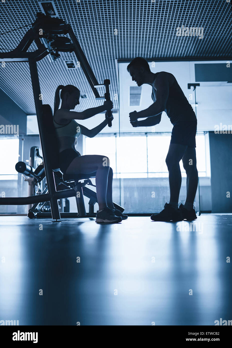 Outlines of female exercising on facilities and her trainer Stock Photo ...