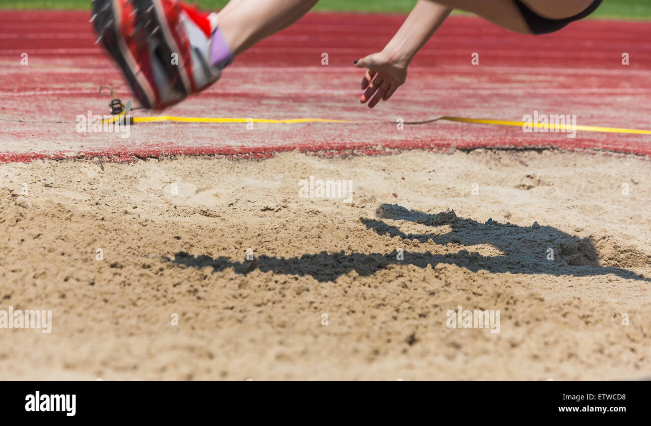 athletics competitions in long jump at the finish Stock Photo - Alamy