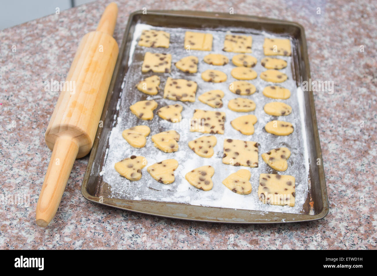 Large assortment of chocolate chip cookies in various shapes before ...