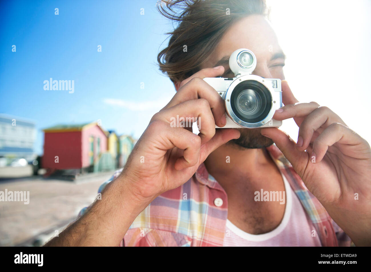 Young man taking picture on the beach Stock Photo - Alamy