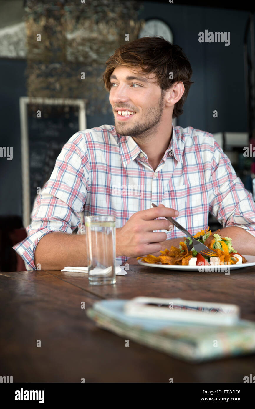 Young man in a restaurant having lunch Stock Photo - Alamy