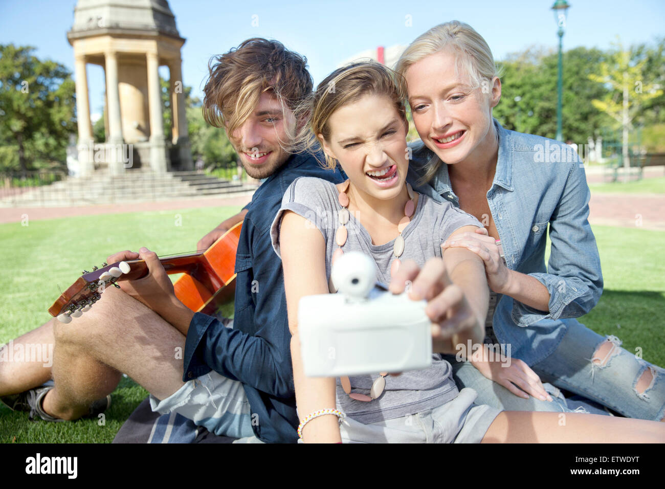 Happy friends in park taking a selfie Stock Photo - Alamy