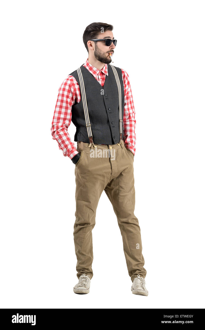 Macho hipster smoking cigarette looking away. Full body length portrait ...