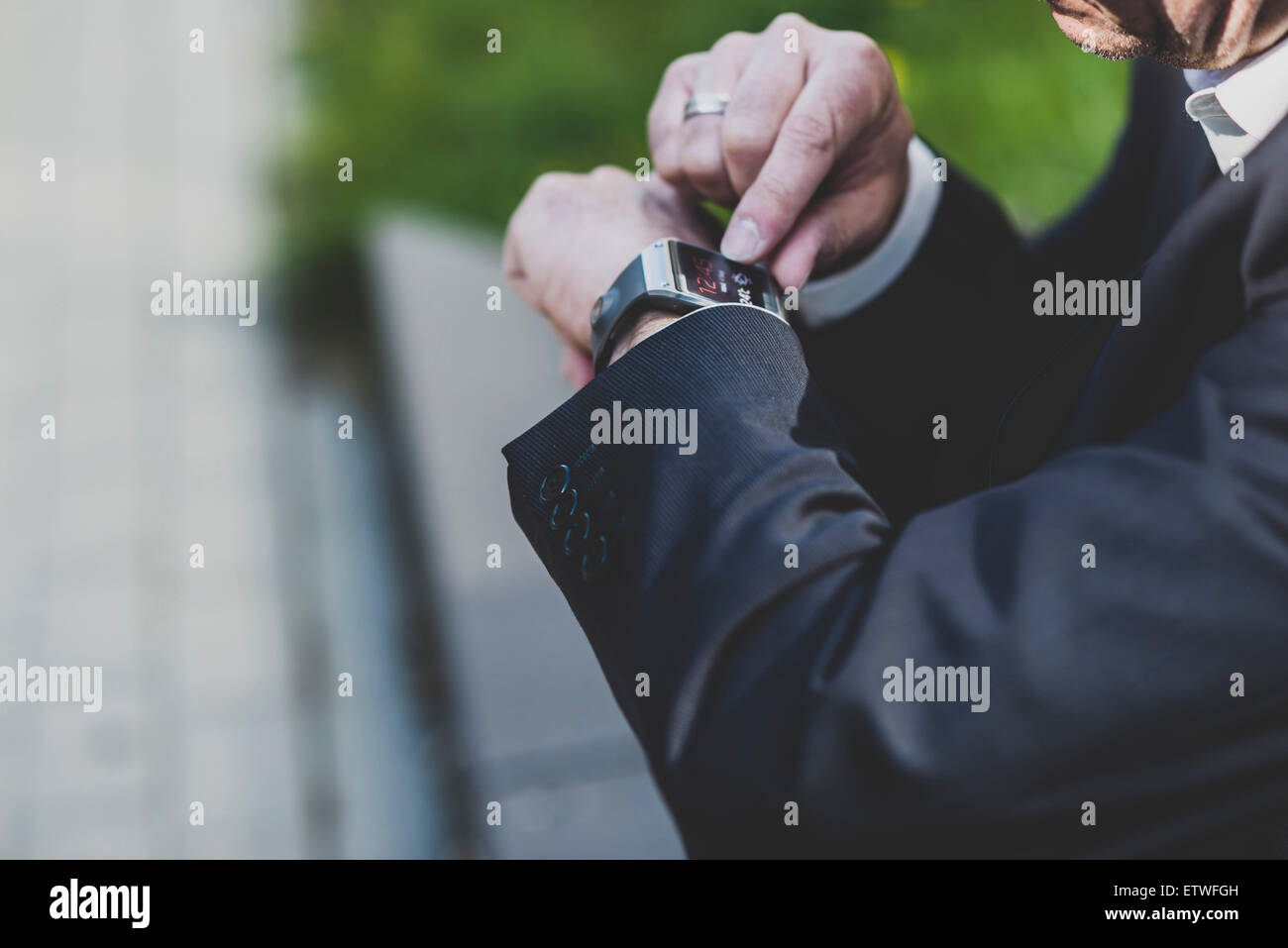 Businessman checking smart watch Stock Photo - Alamy