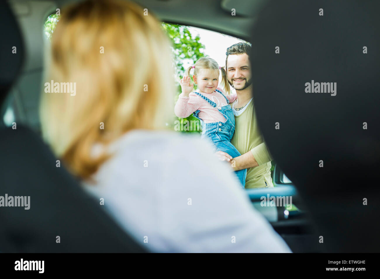 Girl with father saying goodbye to leaving mother in car Stock Photo ...