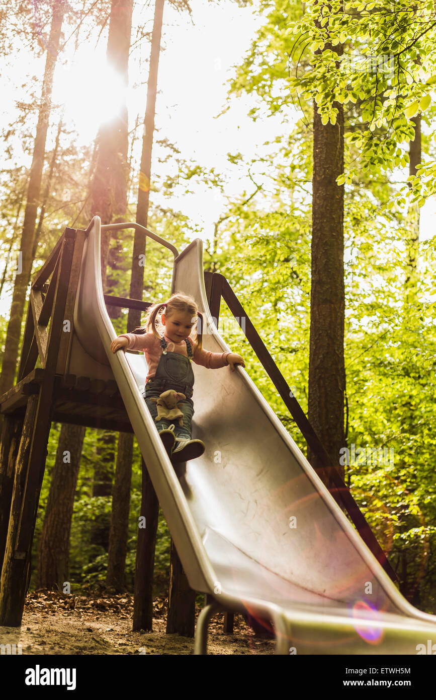Happy girl on a slide Stock Photo - Alamy