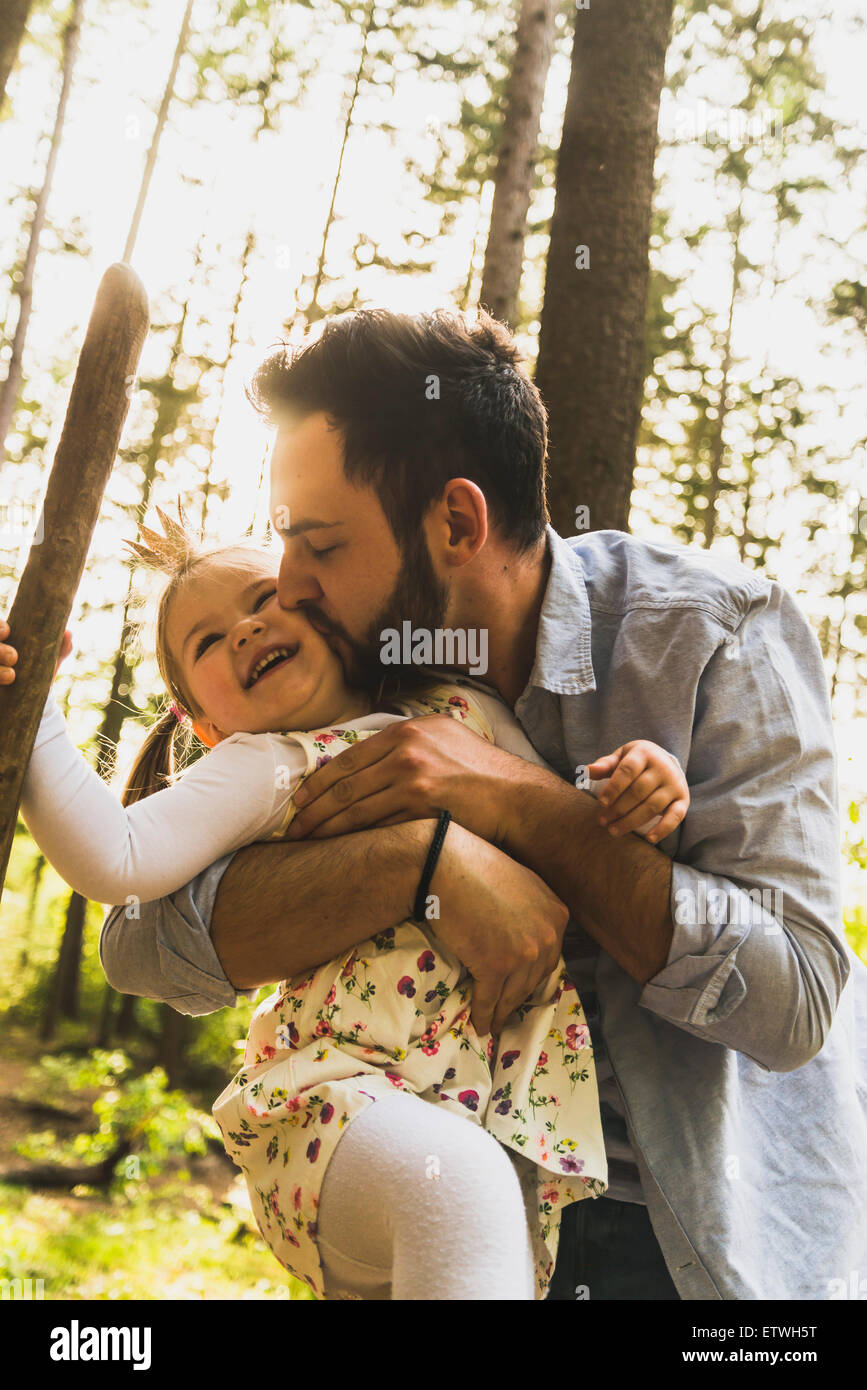 Happy girl with father in forest Stock Photo - Alamy