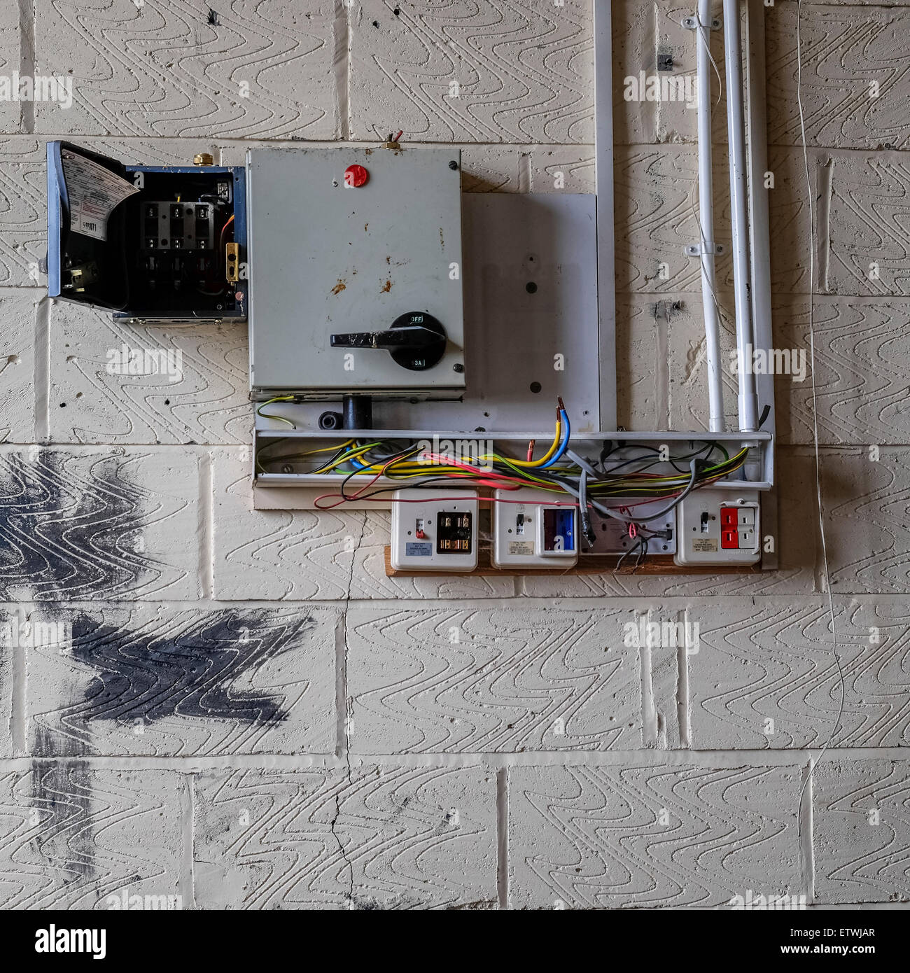 vandalized switchgear in an abandoned factory with exposed wires Stock ...