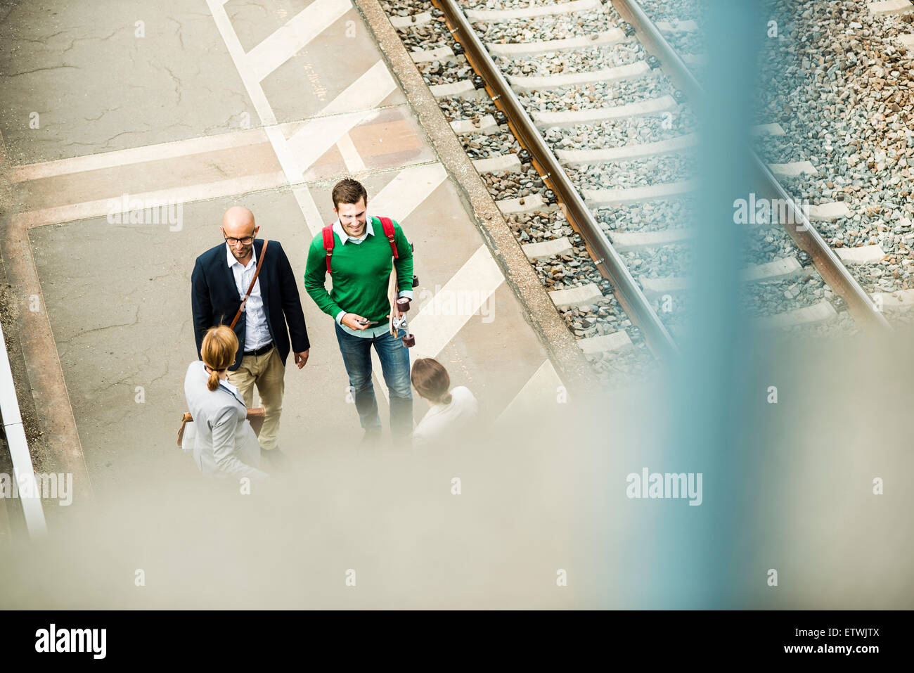 Businesspeople talking on railway platform Stock Photo - Alamy