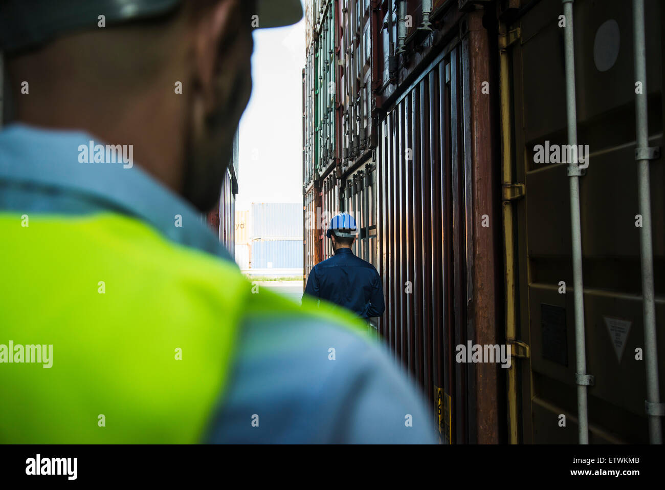 Two men with safety helmets at container port Stock Photo - Alamy